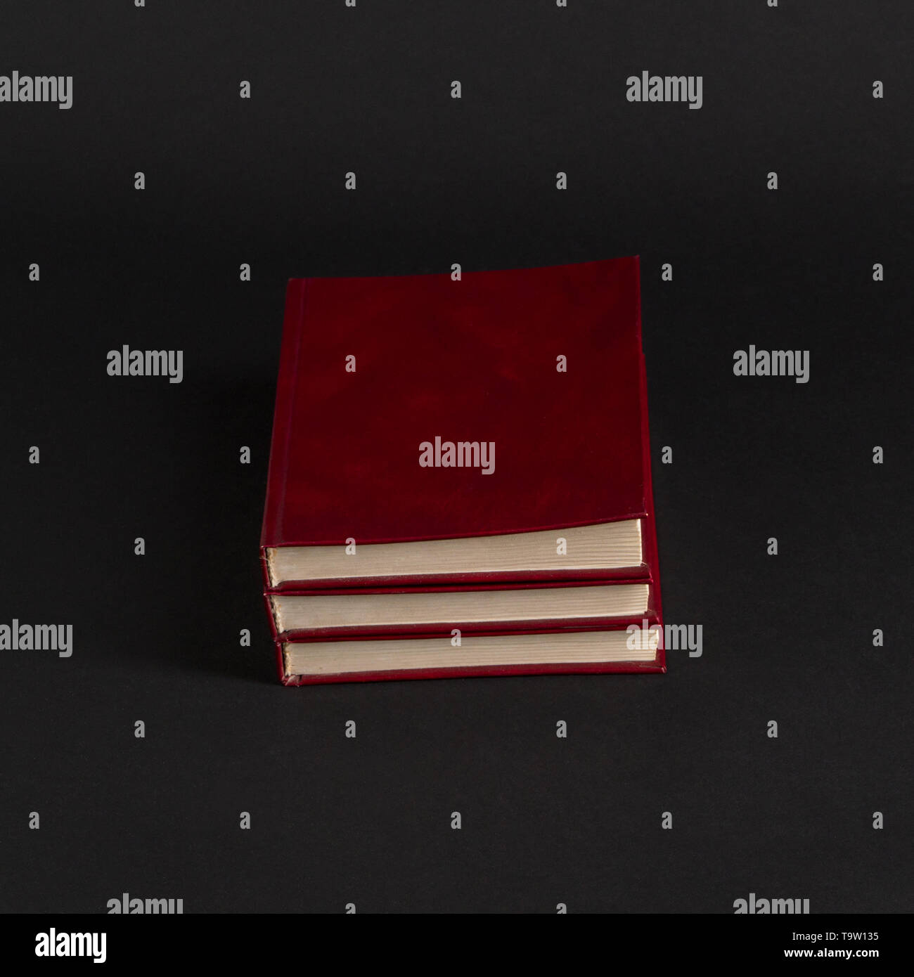 books with red cover on black background, isolated. back to school ...