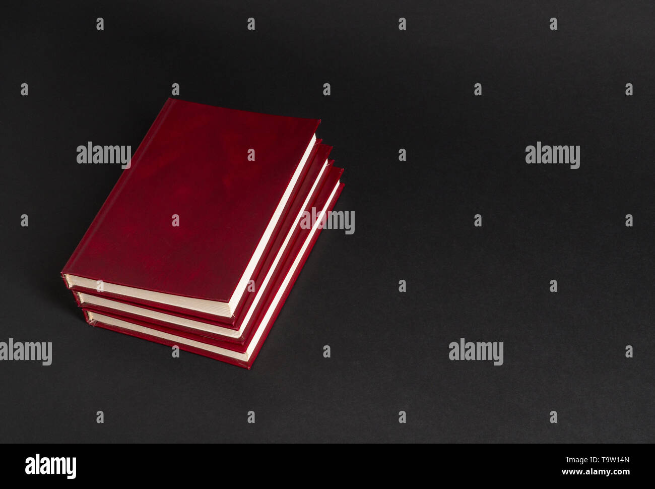 books with red cover on black background, isolated. back to school ...