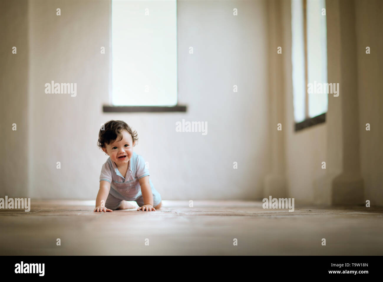 Toddler crawling down hallway Stock Photo - Alamy