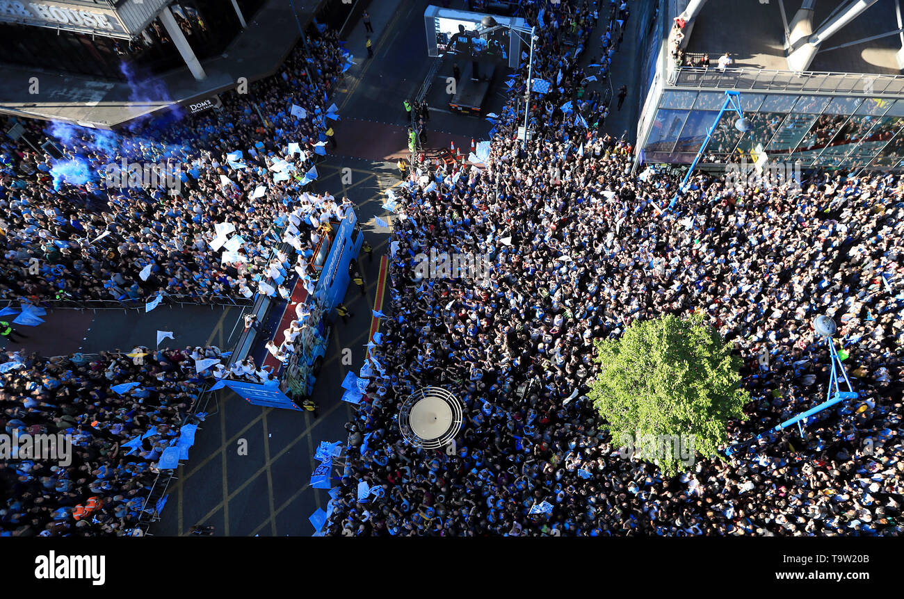 The Manchester City players and staff on the buses pass the crowds of ...