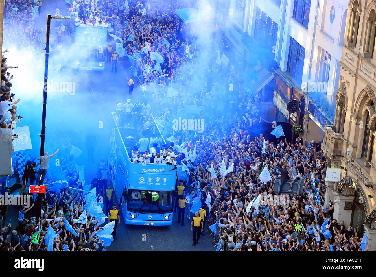 The Manchester City players and staff on the buses pass the crowds of ...