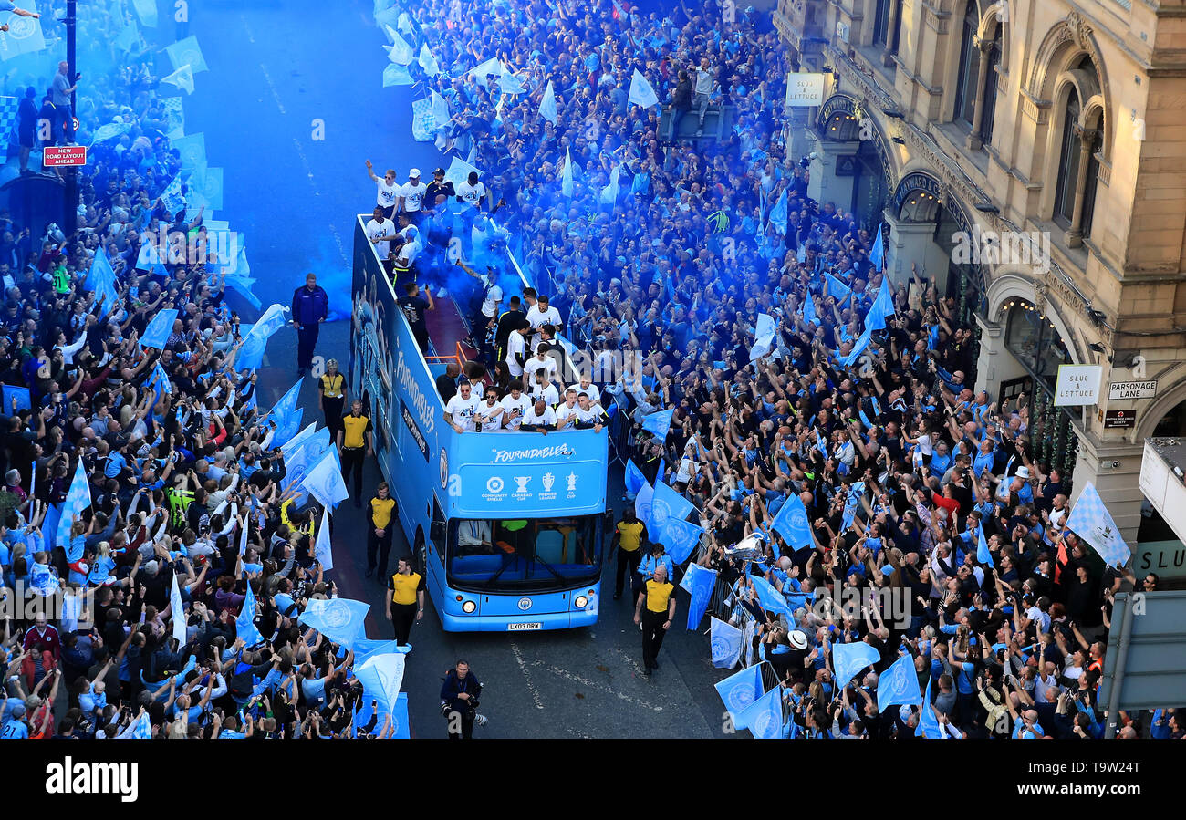 The Manchester City players and staff on the buses pass the crowds of ...