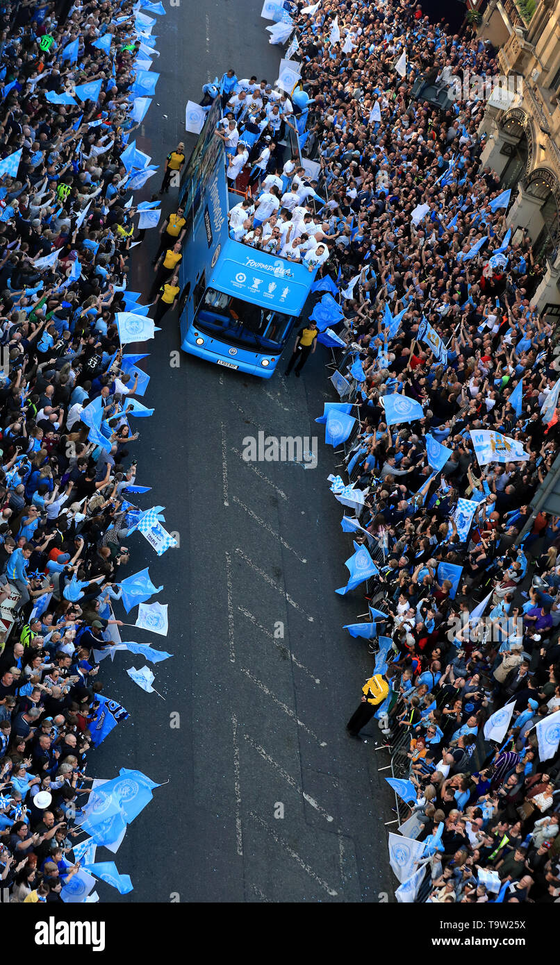 The Manchester City players and staff on the buses pass the crowds of ...