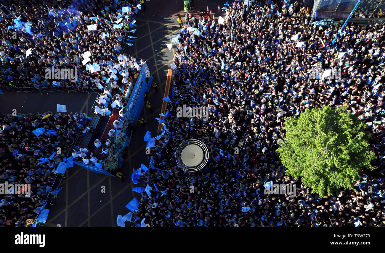 The Manchester City players and staff on the buses pass the crowds of ...