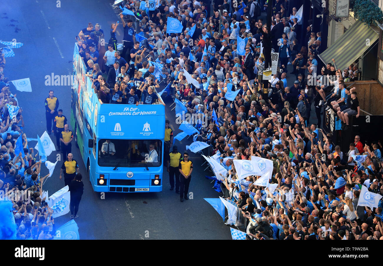 The Manchester City players and staff on the buses pass the crowds of ...