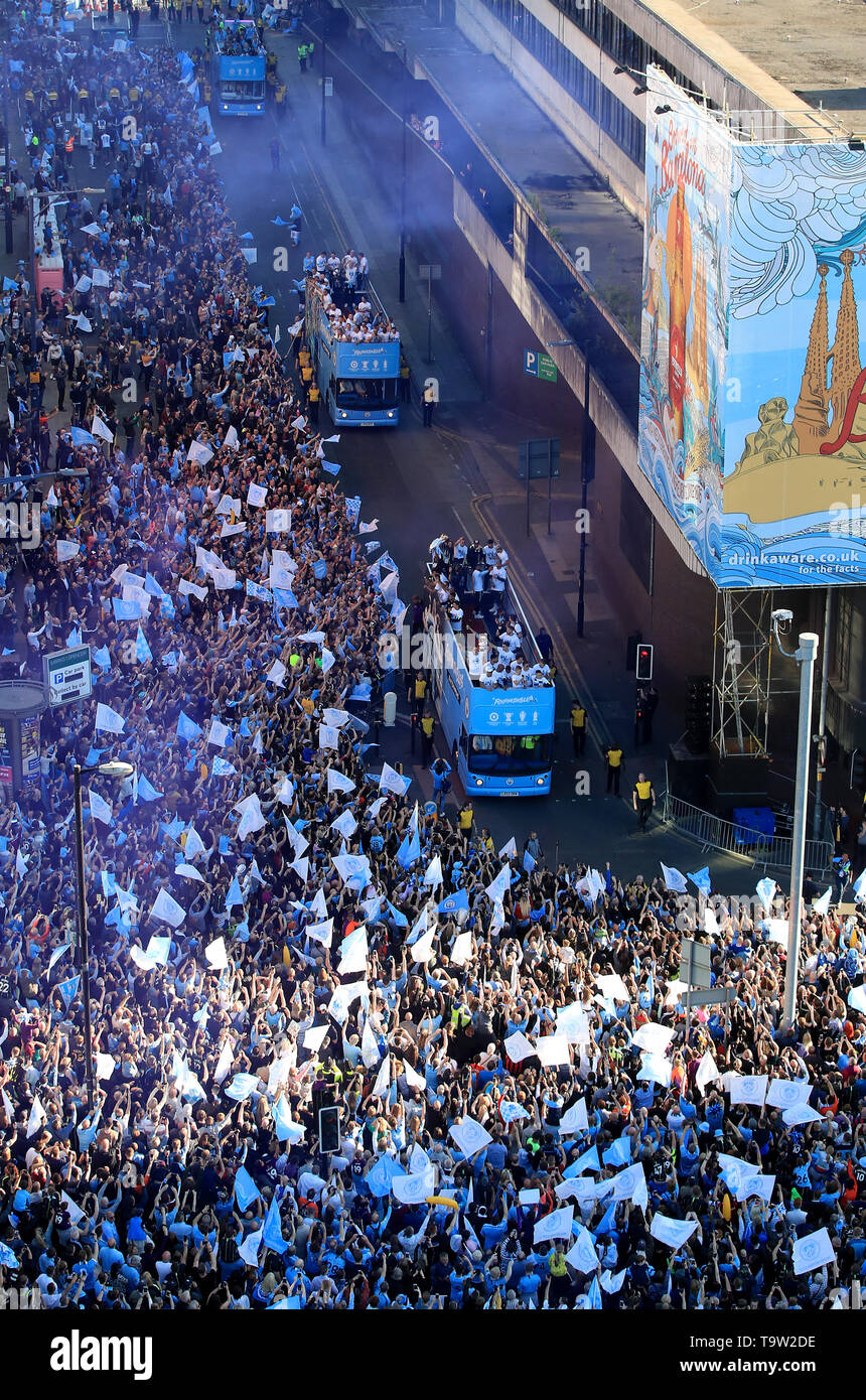 The Manchester City players and staff on the buses pass the crowds of ...