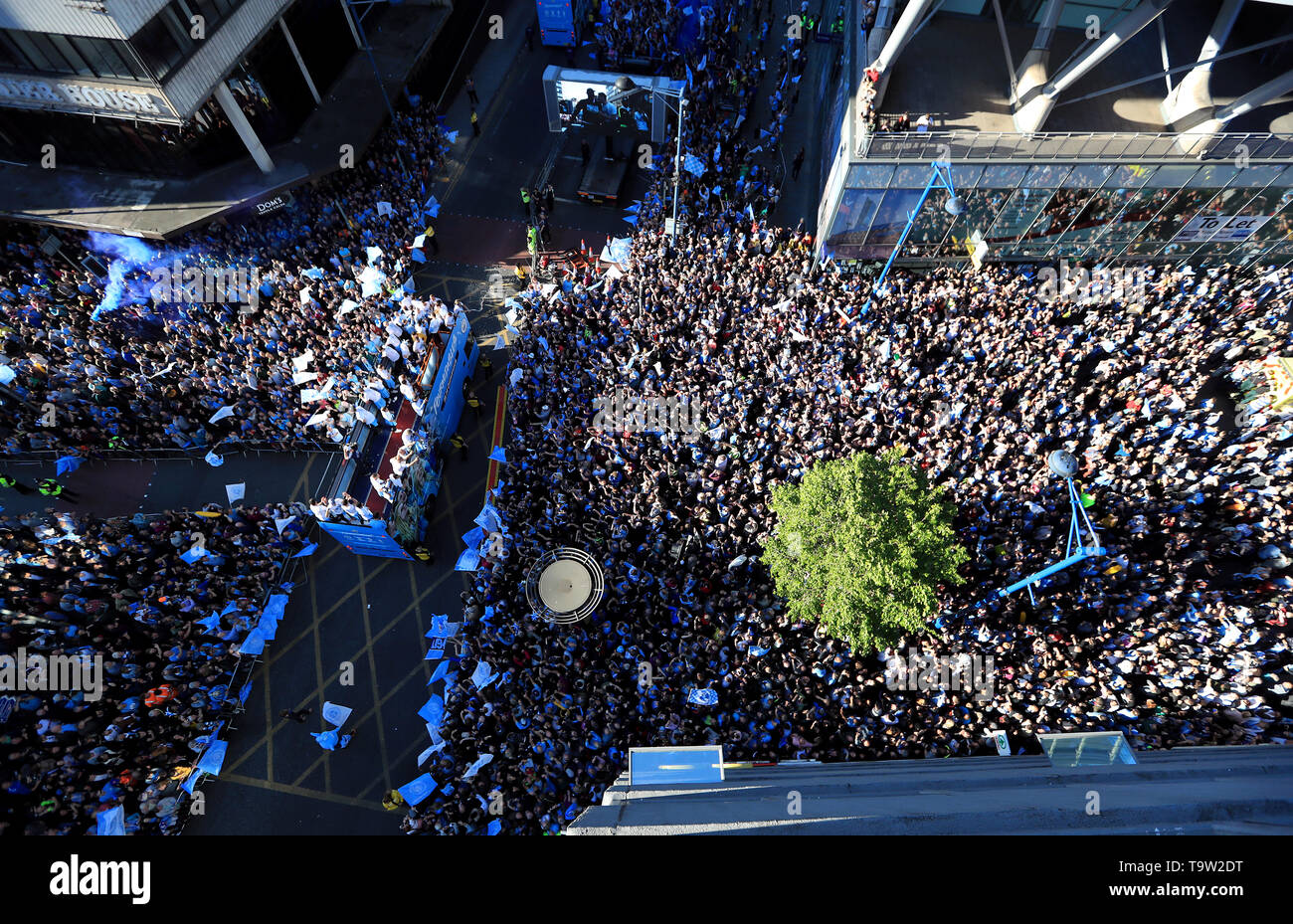 The Manchester City players and staff on the buses pass the crowds of ...
