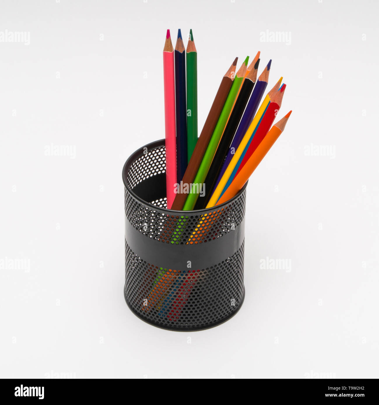 set of colored pencils in a basket on a white background, isolated ...