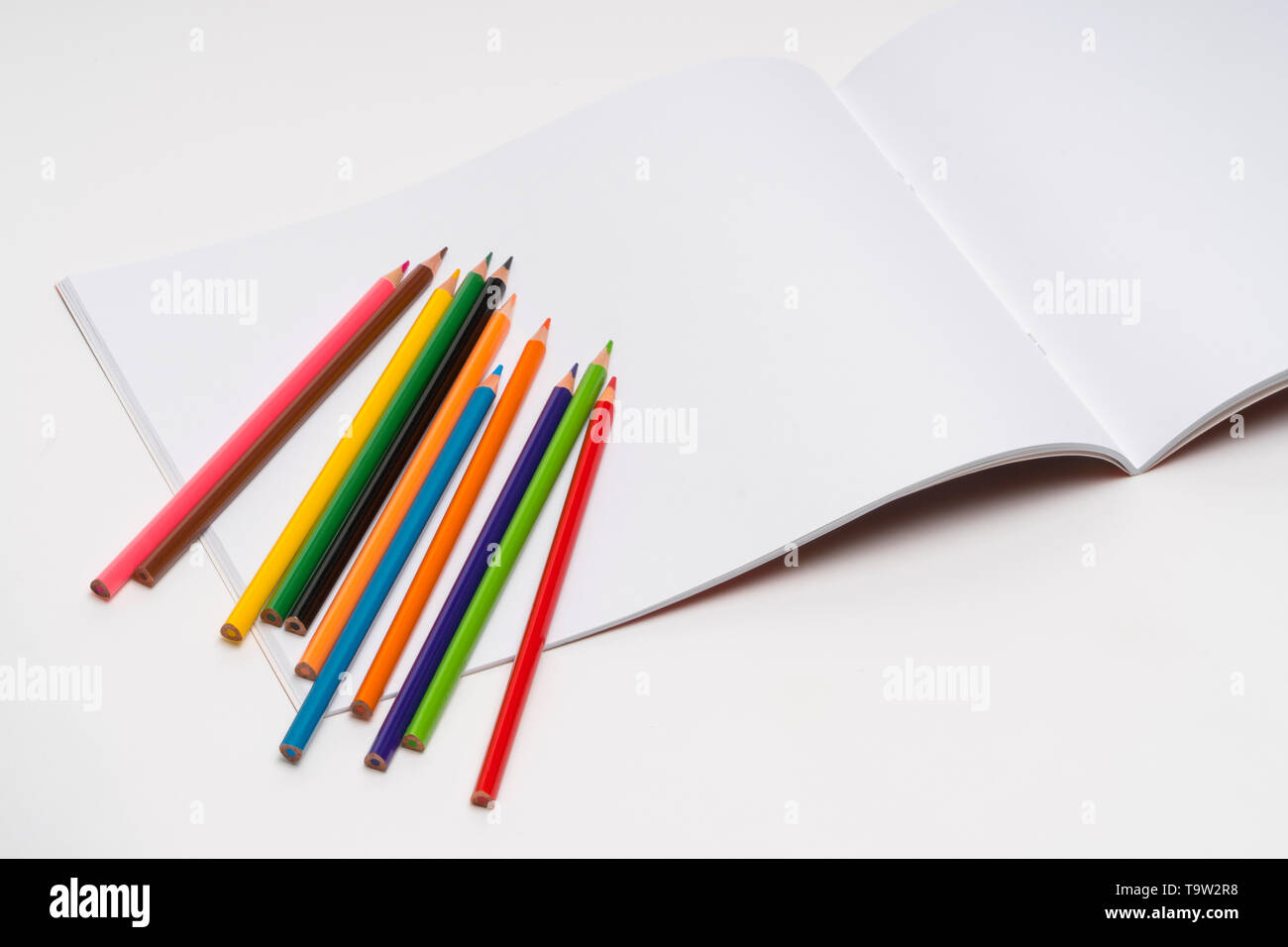 drawing album and color pencils on a white background. back to school ...