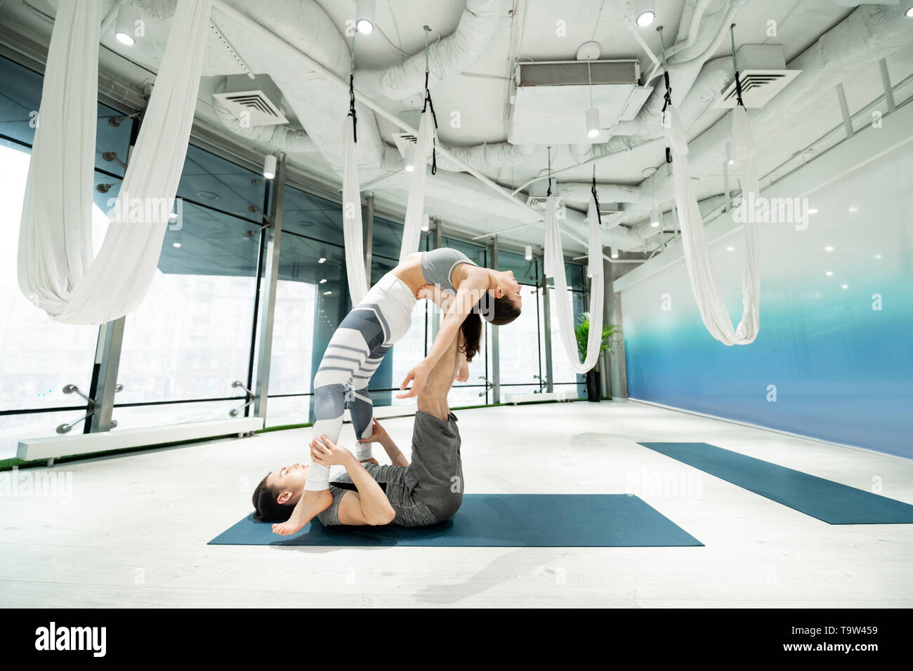 Sport young couple having amazing yoga training together Stock Photo ...