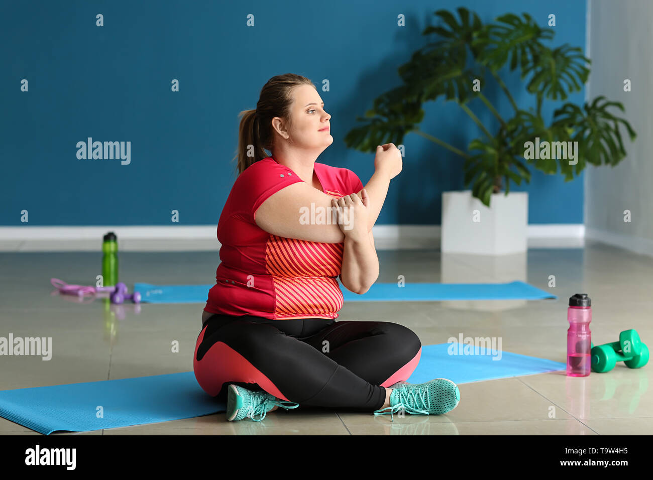 Beautiful plus size girl training in gym. Concept of body positivity ...