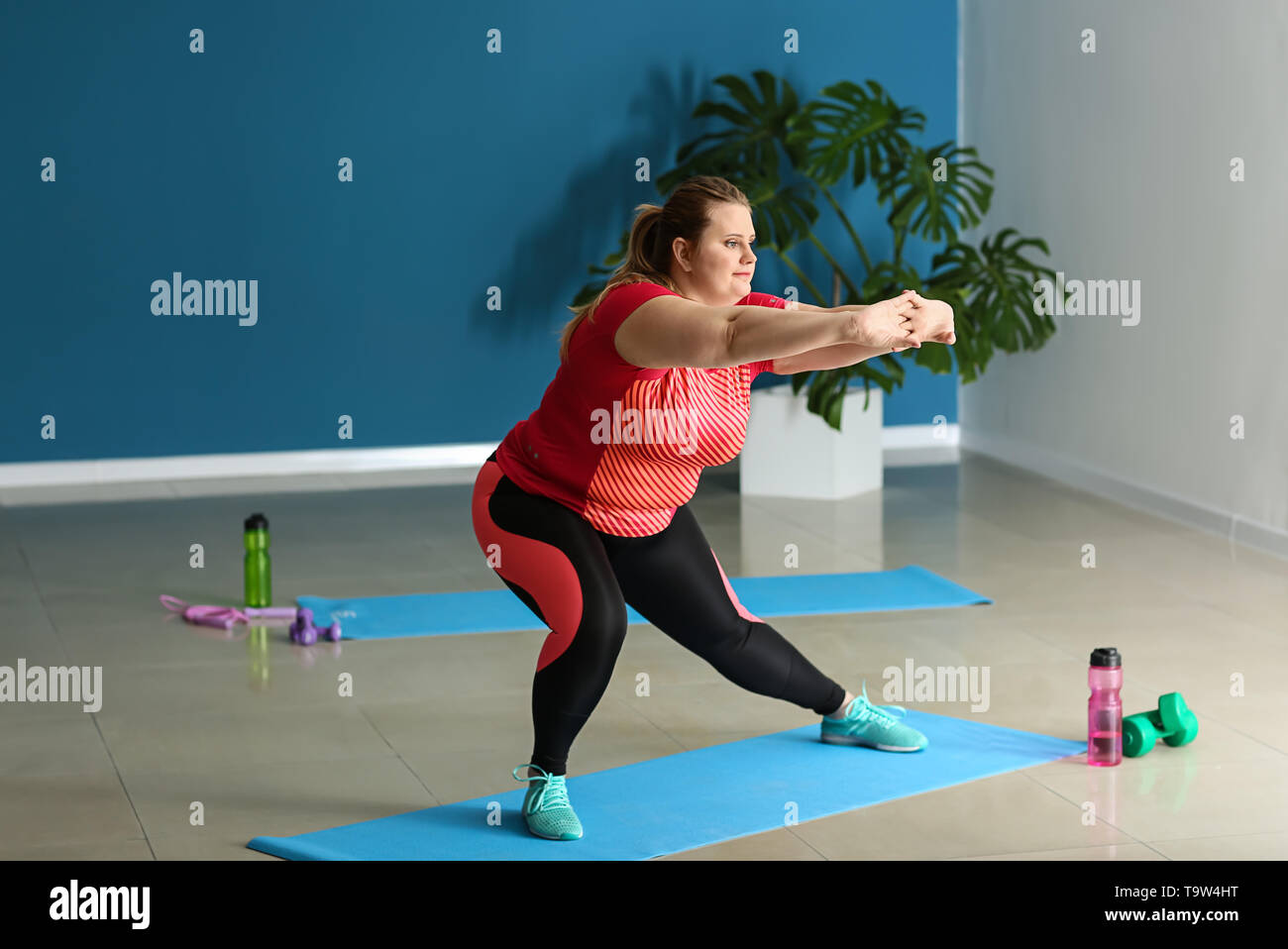 Beautiful plus size girl training in gym. Concept of body positivity ...
