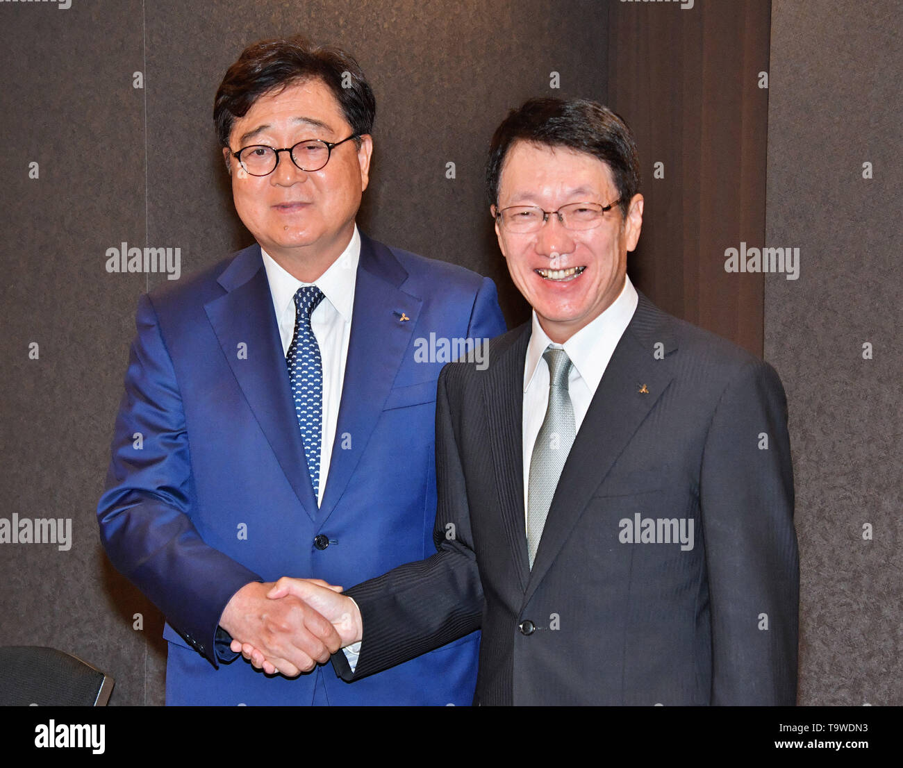 Chairman of Mitsubishi Motors Osamu Masuko (L) and New CEO Takao Kato ...