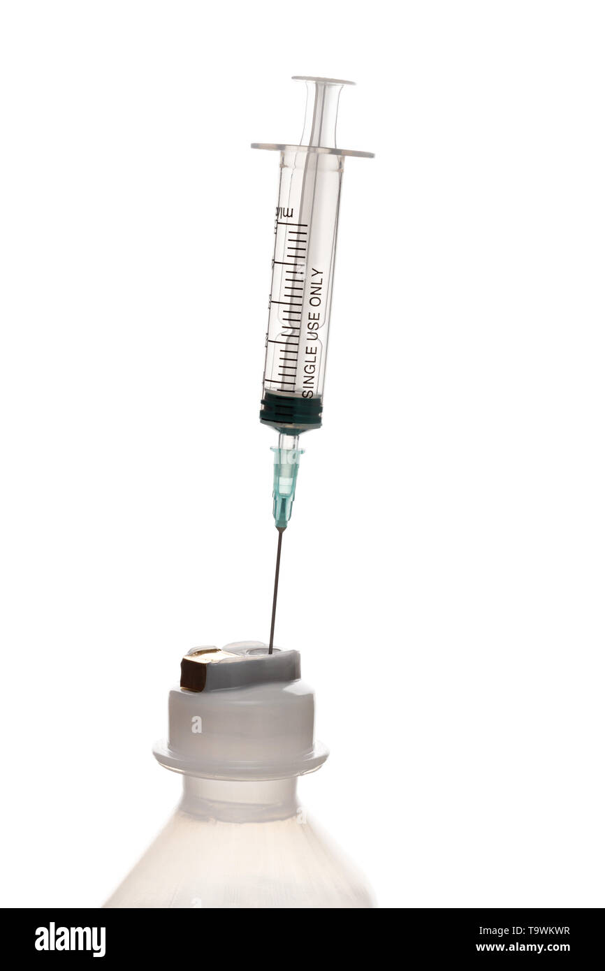 Empty syringe for injection with a neck of a plastic bottle on a white ...
