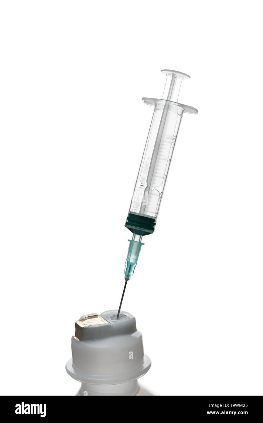 Empty syringe for injection with a neck of a plastic bottle on a white ...