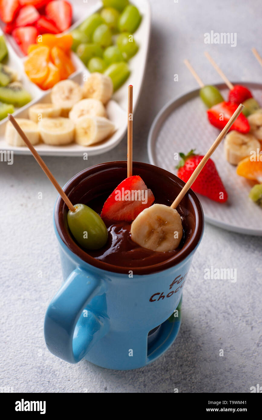 Sweet chocolate fondue with fruits Stock Photo - Alamy