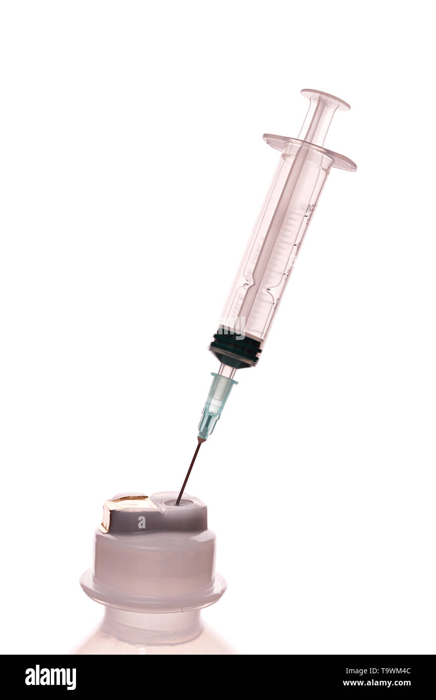 Empty syringe for injection with a neck of a plastic bottle on a white ...