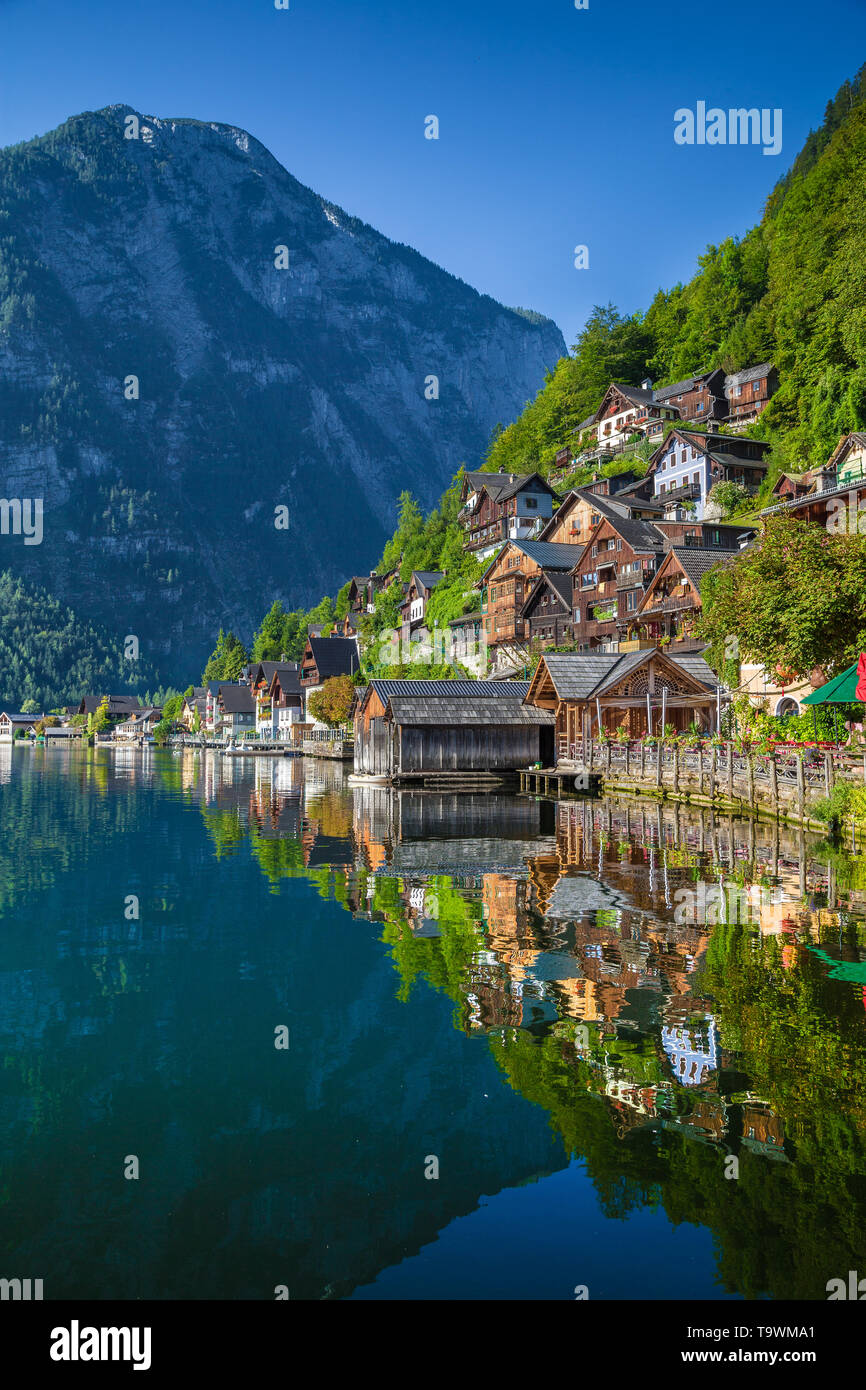 Scenic picture-postcard view of traditional old wooden houses in famous Hallstatt mountain ...