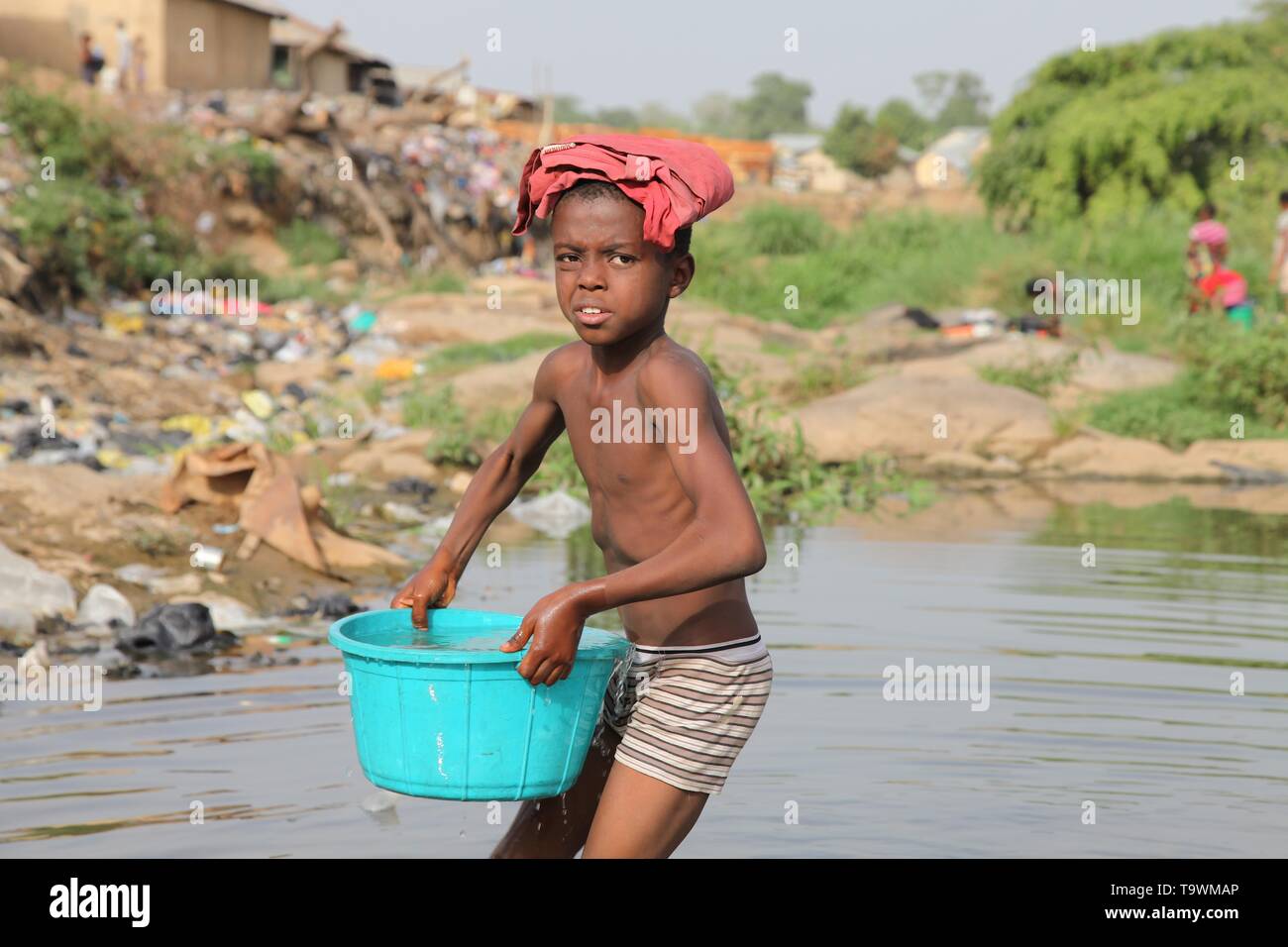 Children taking water on the river Stock Photo - Alamy