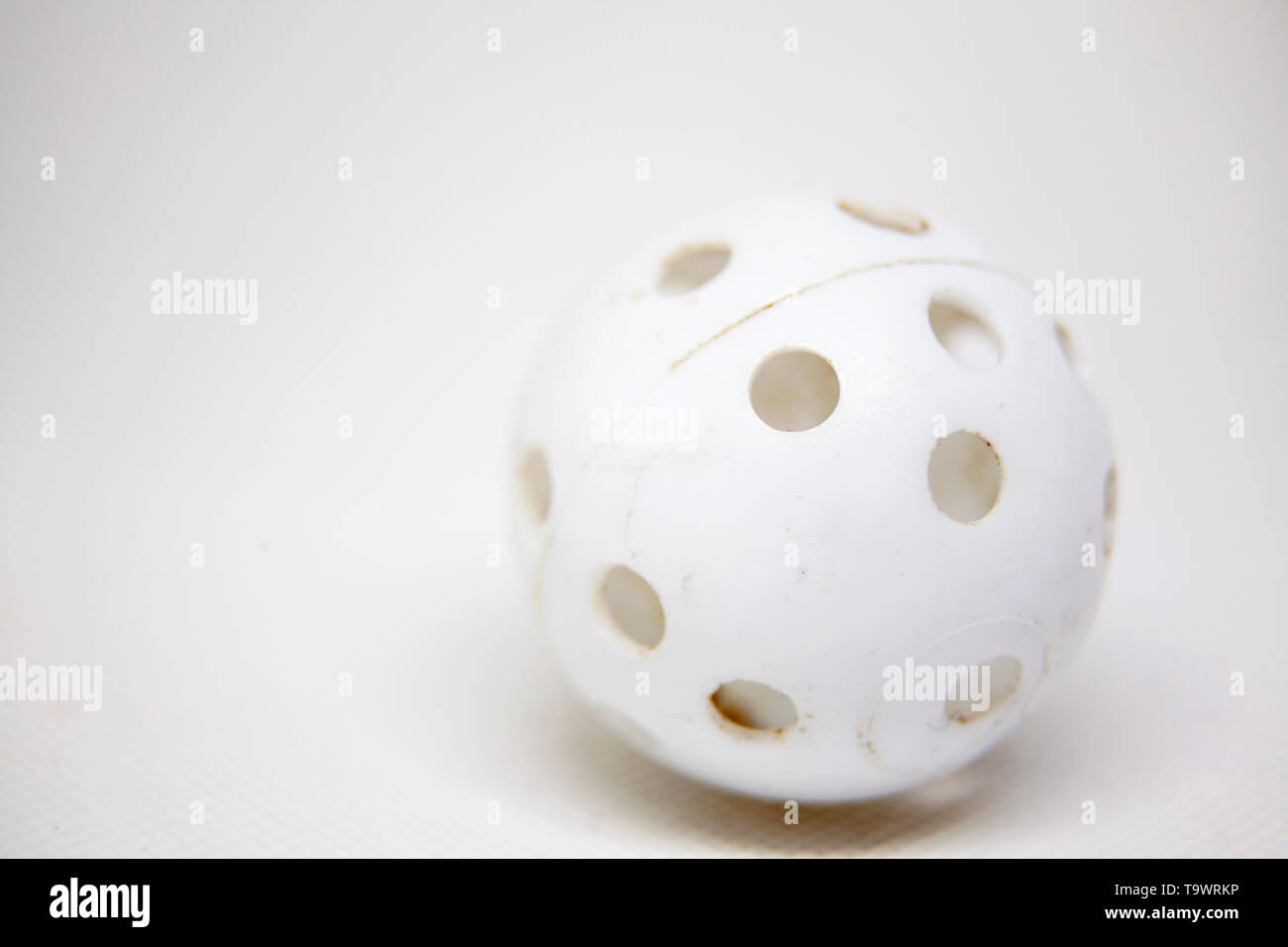 floorball ball on white background Stock Photo - Alamy