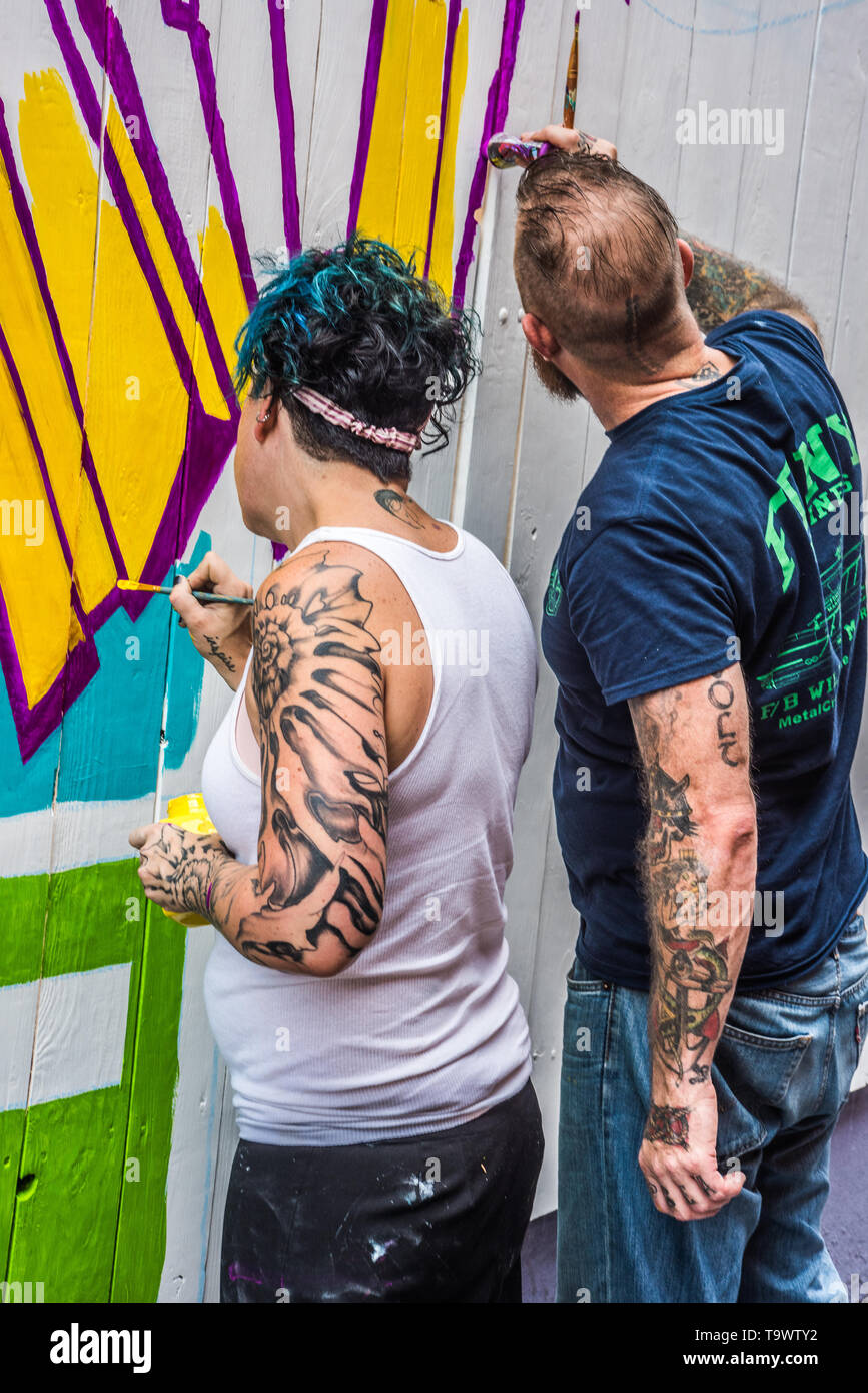 Artist paint mural on back alley fence Stock Photo - Alamy