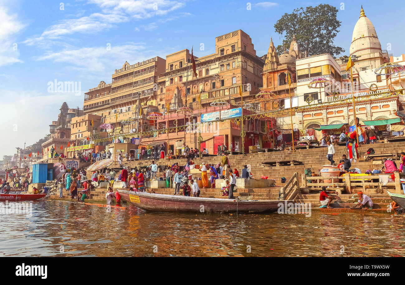 Varanasi Ganges river ghat at sunrise with tourists and pilgrims on the ...