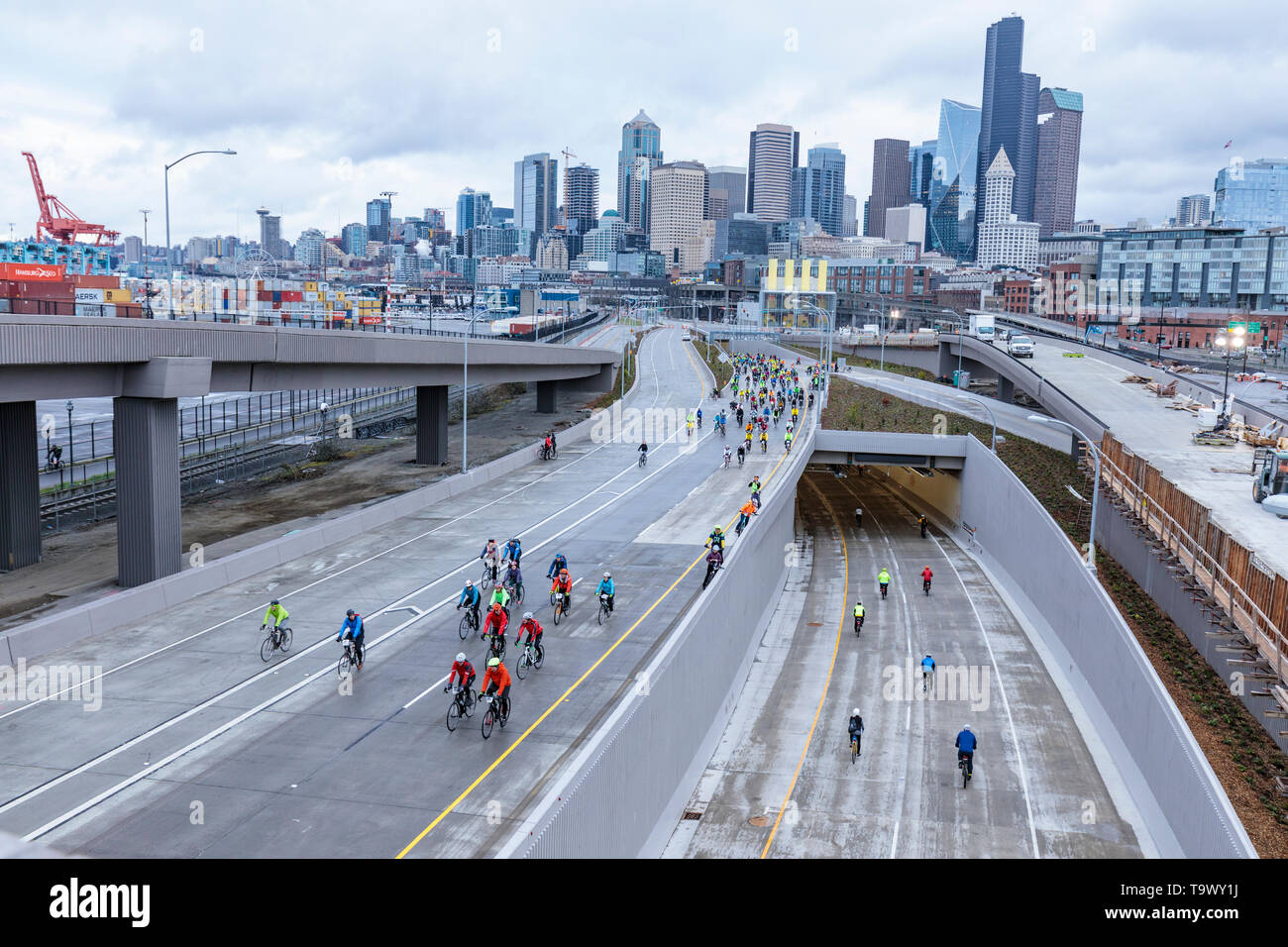 Bicycle riders tour the newly completed highway 99 tunnel that goes ...