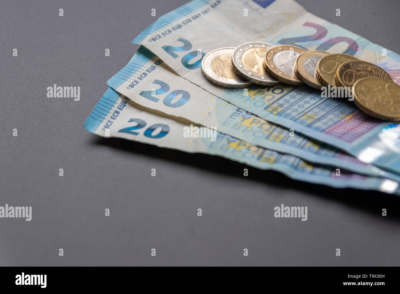 Stack of 20 euro banknotes with 2 euro coins, 1 euro coins and 50 cent ...