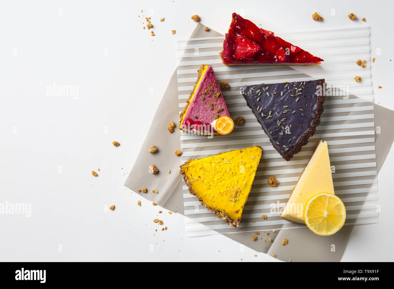 Pieces of tasty cakes on white table Stock Photo - Alamy