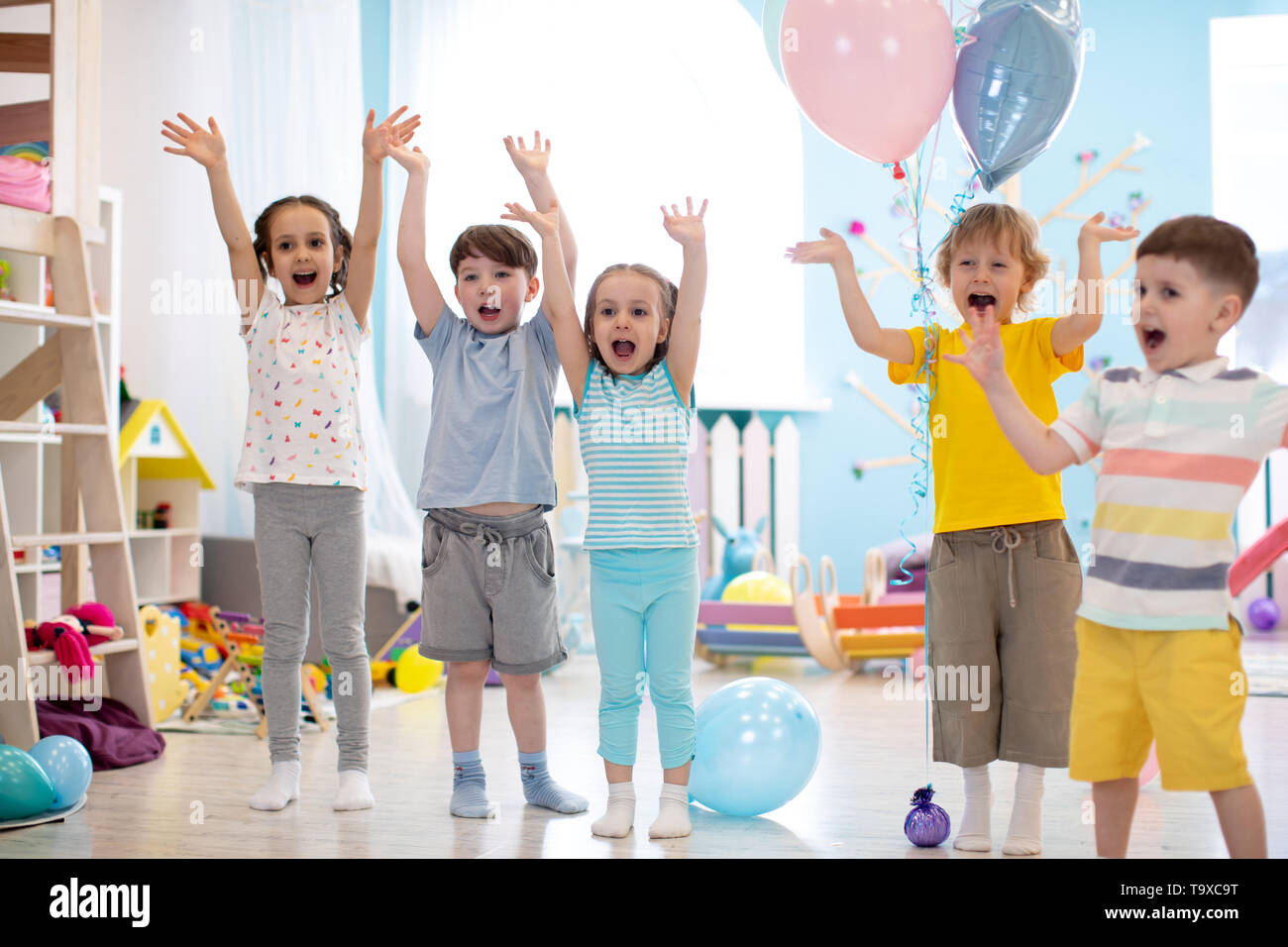 Group of emotional children friends with their hands raised. Kids have ...