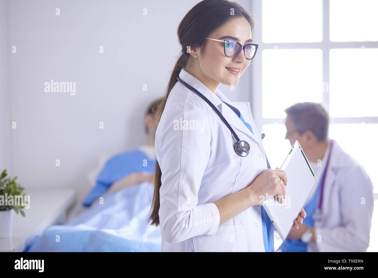 Doctor checking heart beat of patient in bed with stethoscope Stock ...