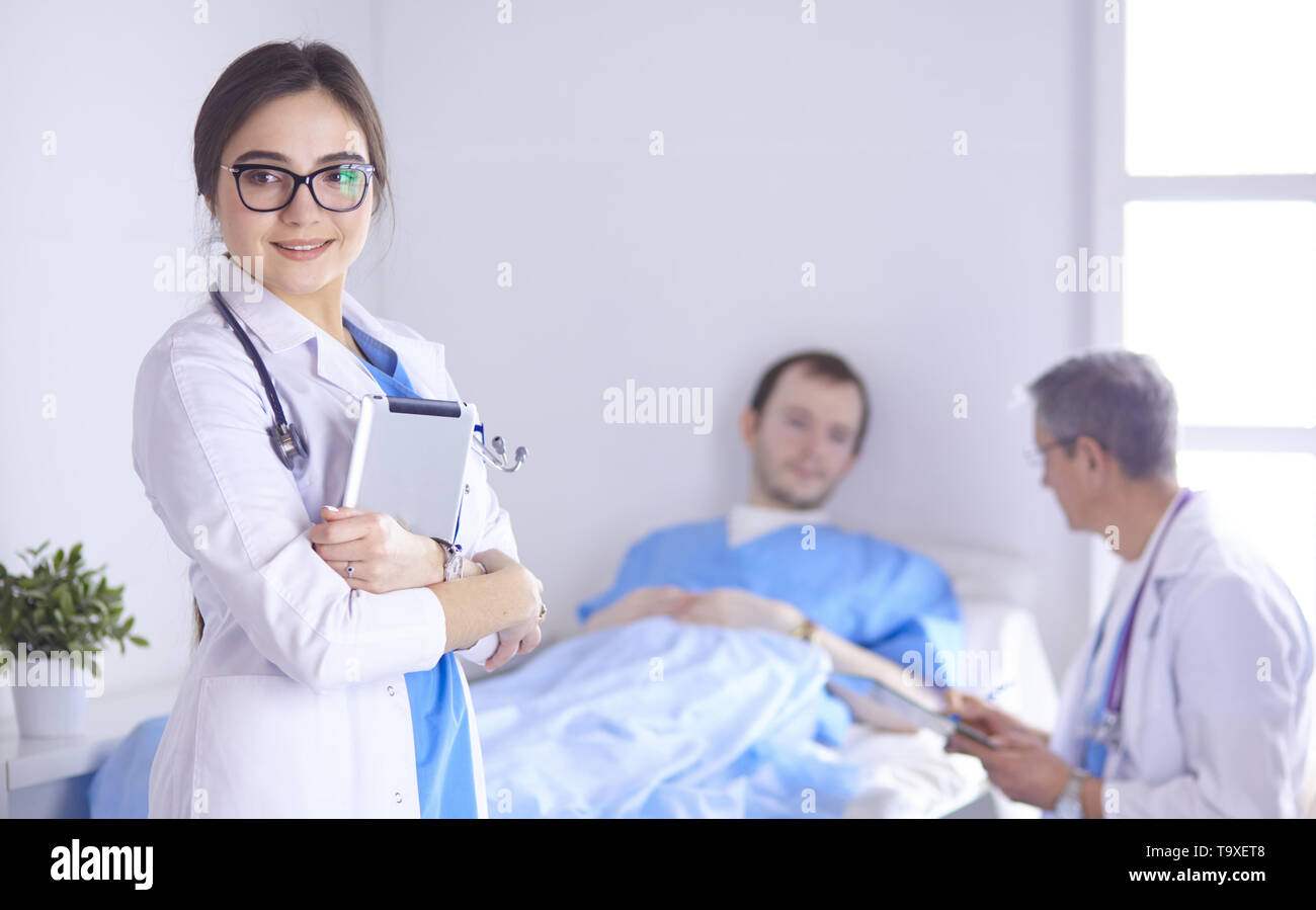 Doctor checking heart beat of patient in bed with stethoscope Stock ...