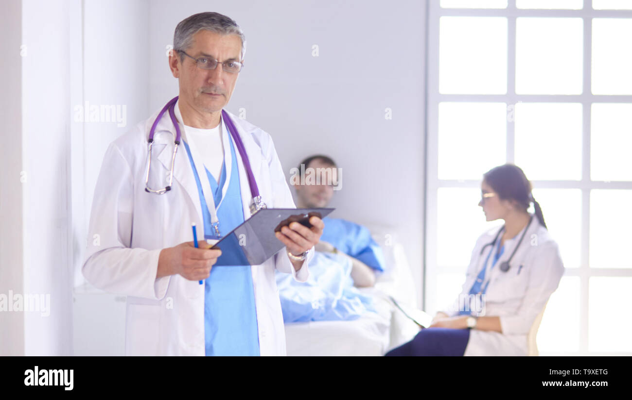 Doctor checking heart beat of patient in bed with stethoscope Stock ...