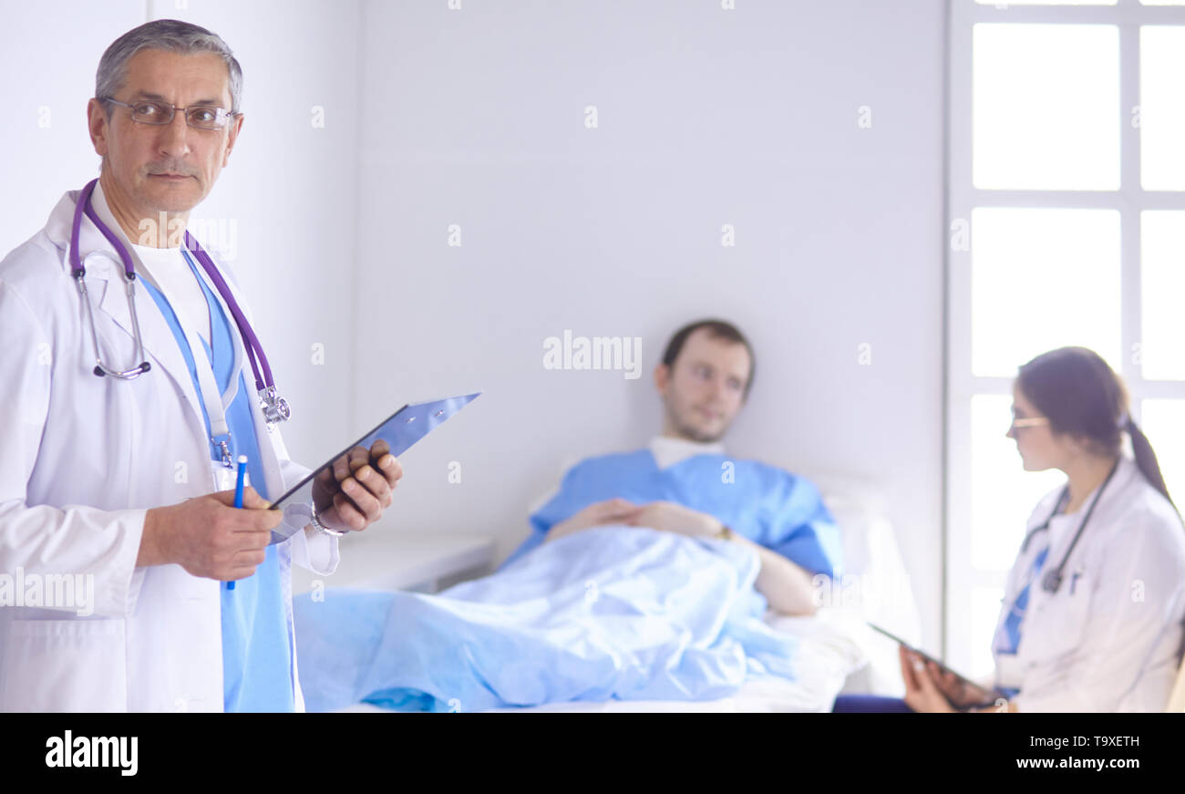 Doctor checking heart beat of patient in bed with stethoscope Stock ...