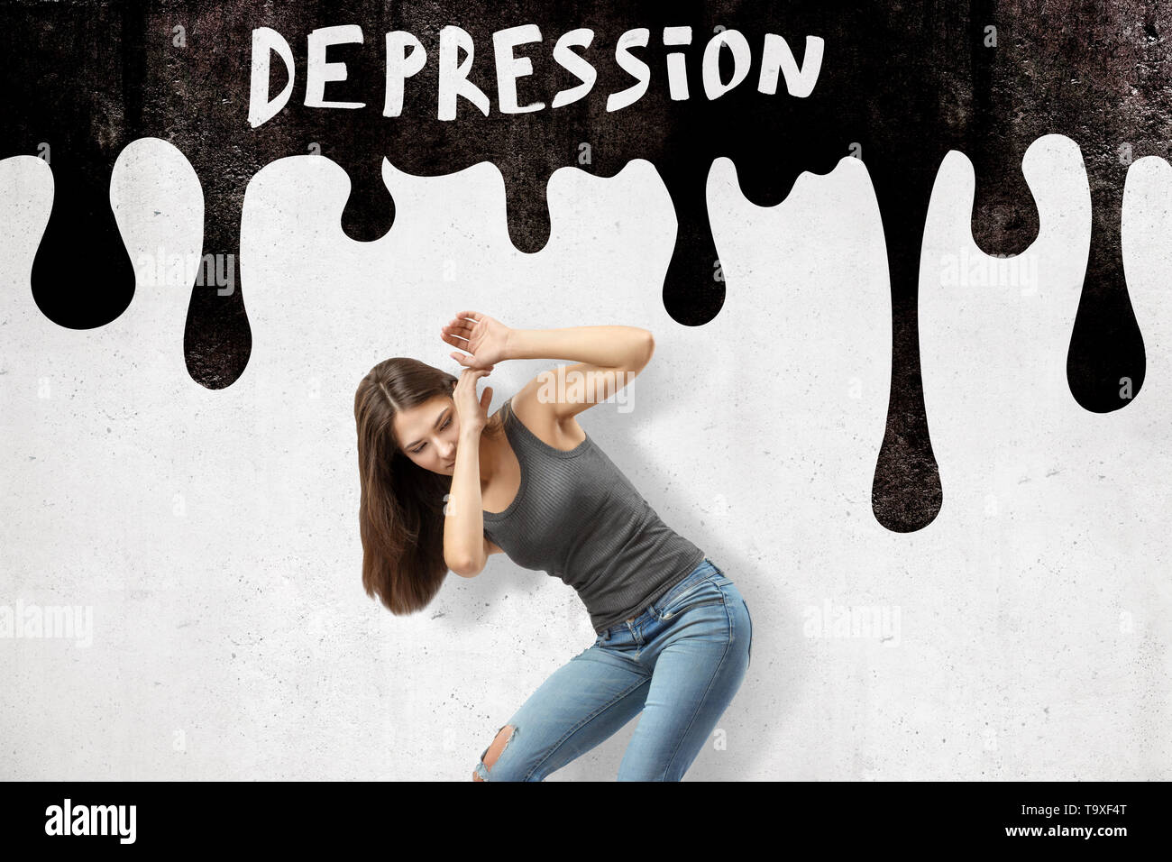 Young brunette girl wearing casual jeans and t-shirt protecting herself ...