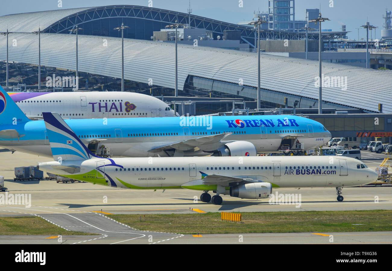 Osaka, Japan - Apr 18, 2019. Passenger airplanes taxiing on runway of ...