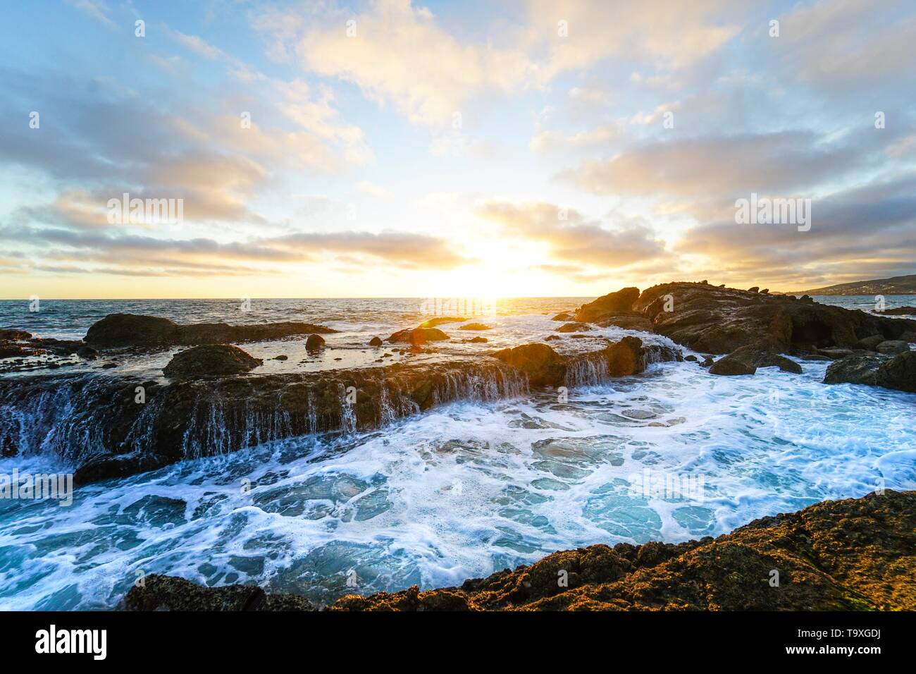 A beautiful sunset taken from a tidepool in Laguna Beach, California ...