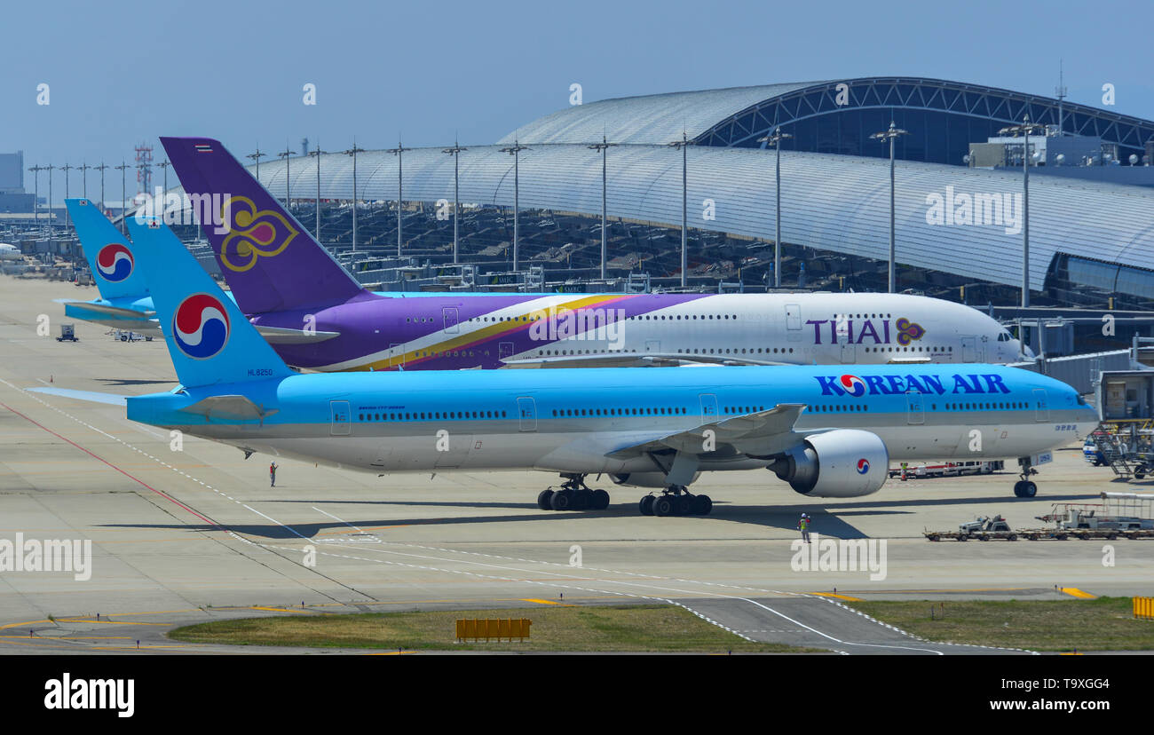Osaka, Japan - Apr 18, 2019. Passenger airplanes taxiing on runway of ...