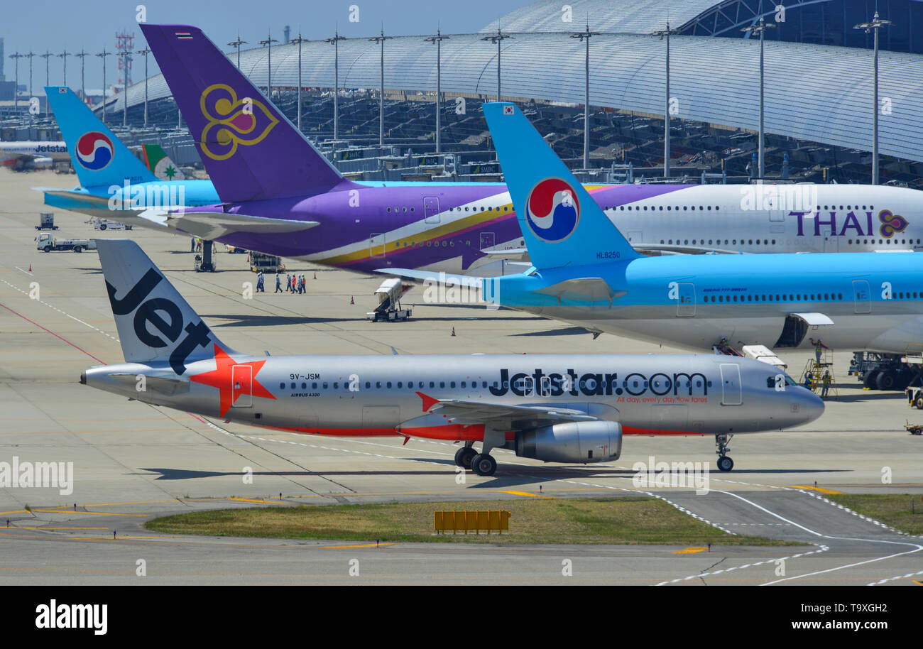 Osaka, Japan - Apr 18, 2019. Passenger airplanes taxiing on runway of ...