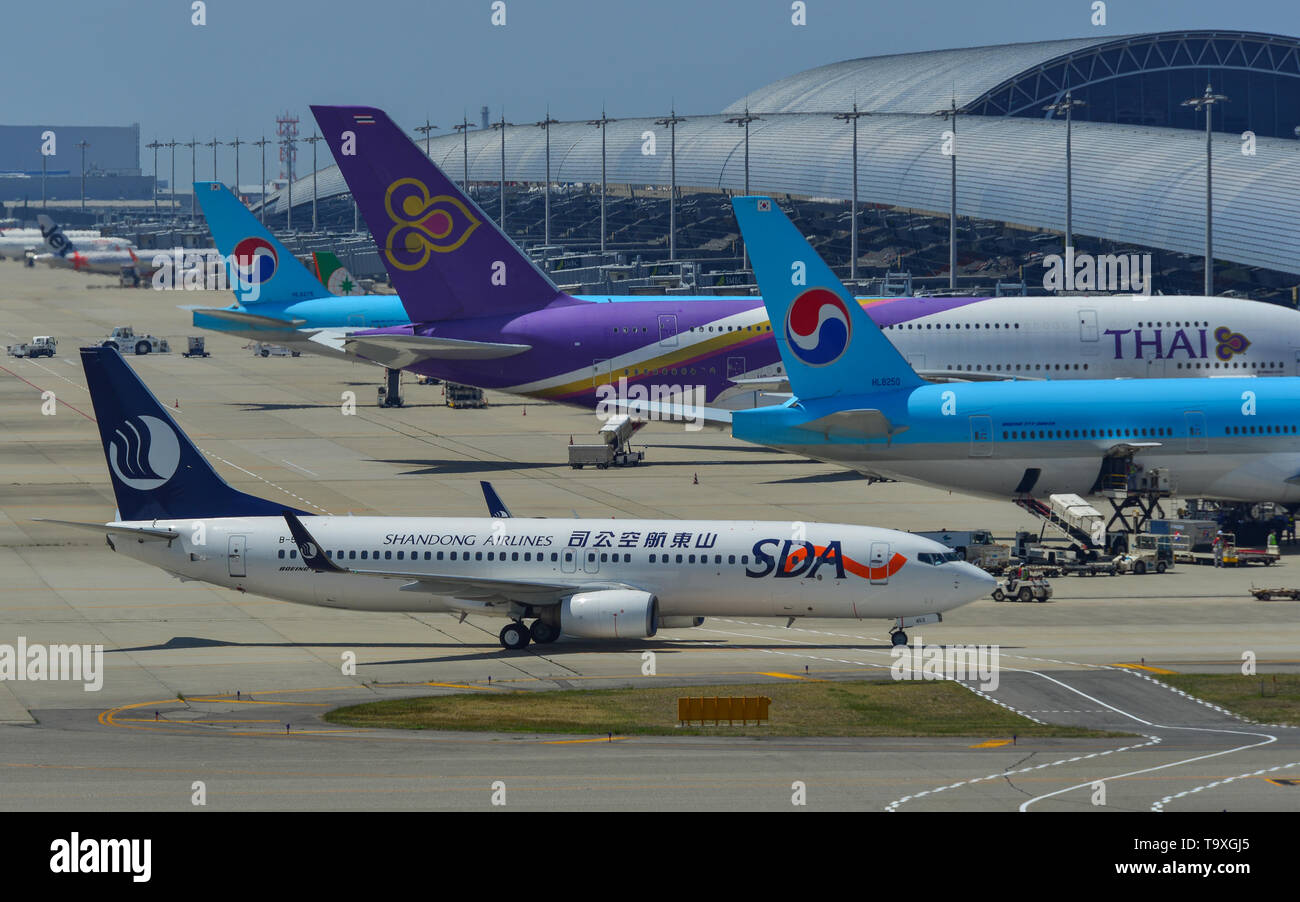 Osaka, Japan - Apr 18, 2019. Passenger airplanes taxiing on runway of ...