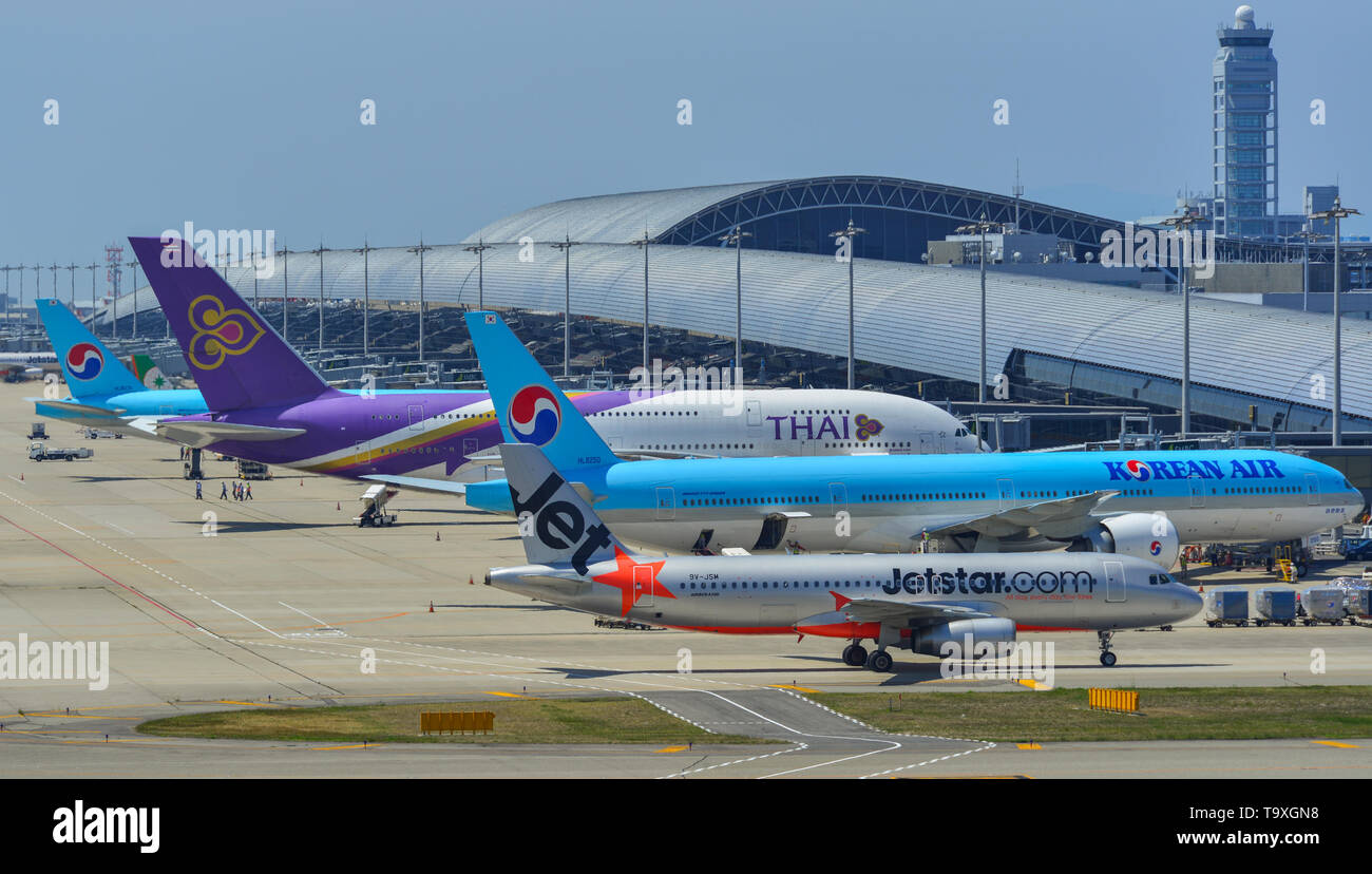 Osaka, Japan - Apr 18, 2019. Passenger airplanes taxiing on runway of ...