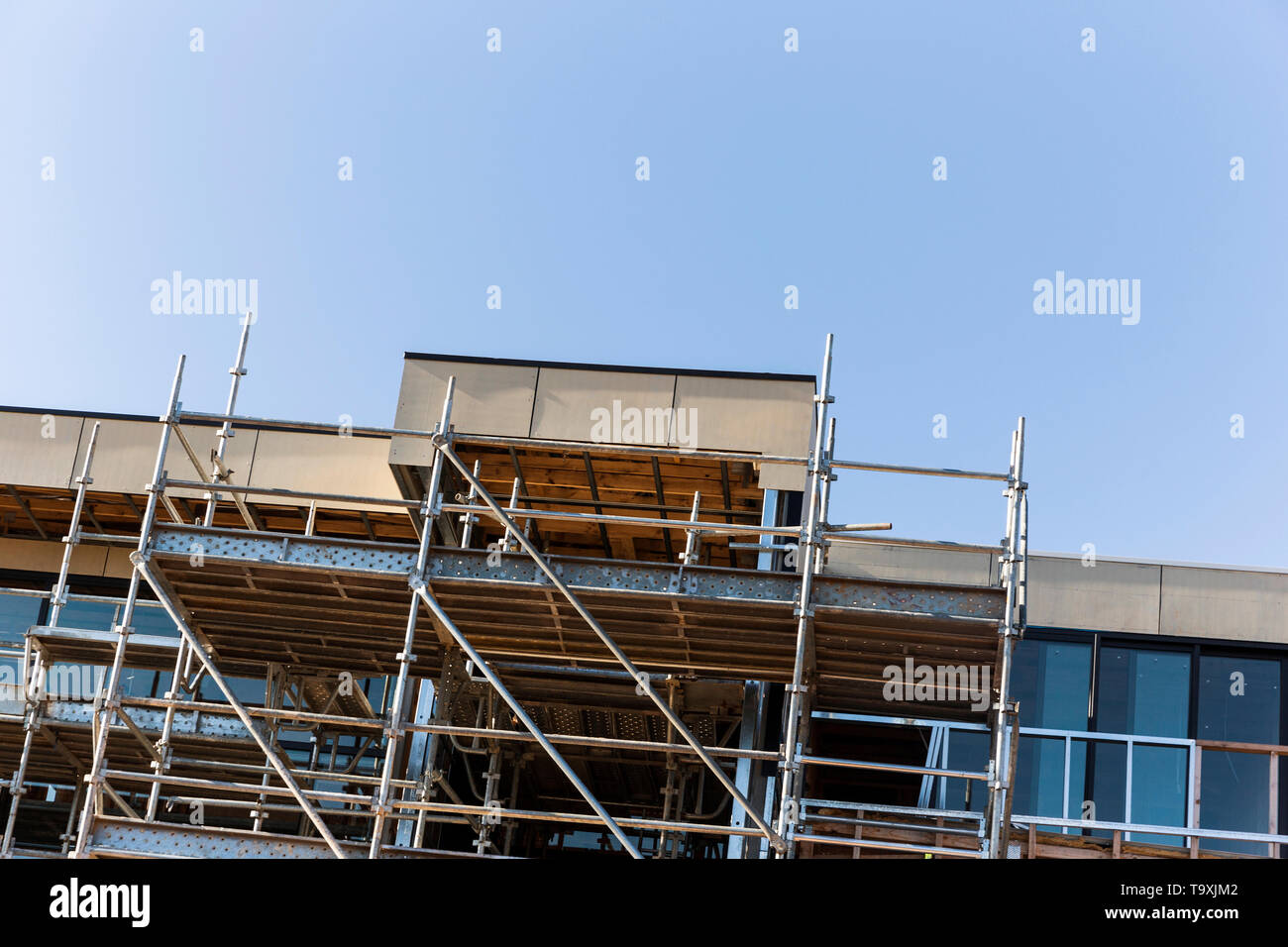 Construction scaffolding standing in front of a housing development ...