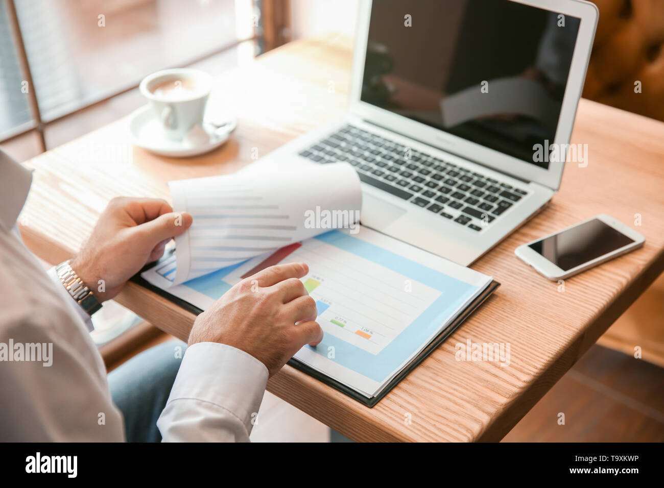 Young businessman working in cafe Stock Photo - Alamy