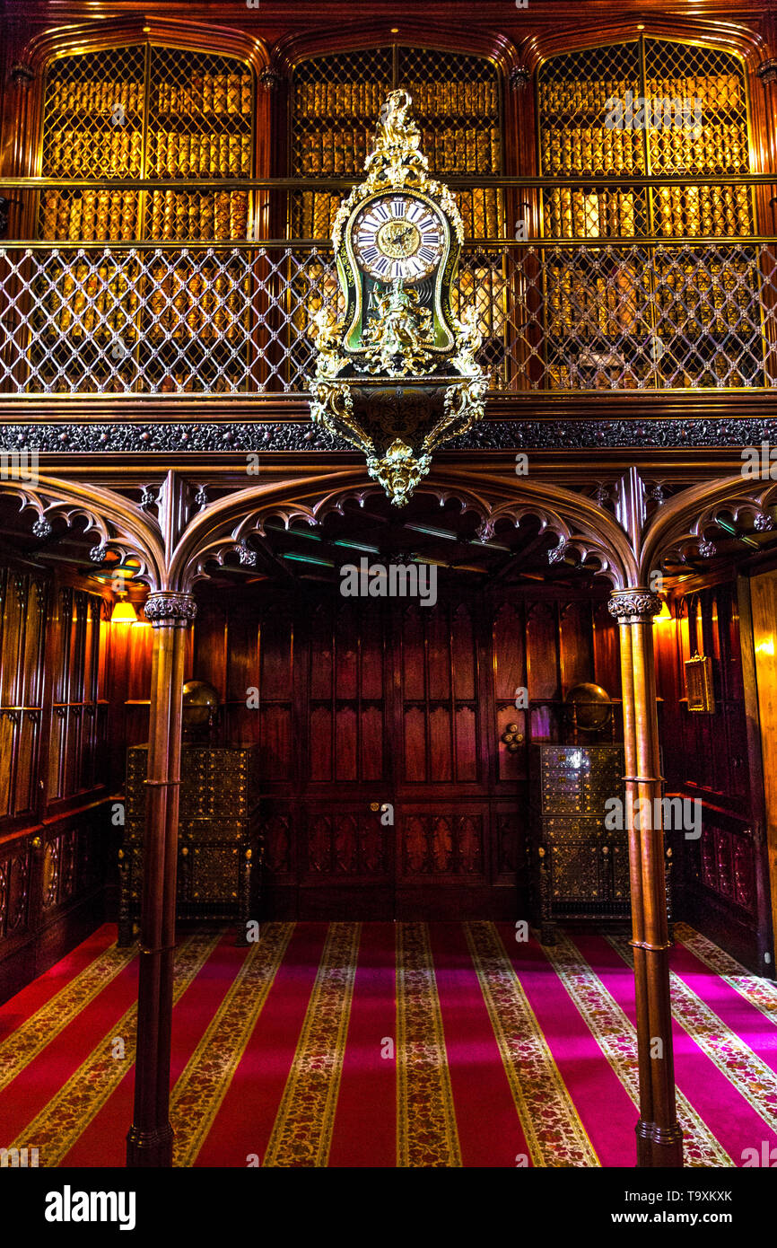 Interior of the carved mahogany library with clock at Arundel Castle ...