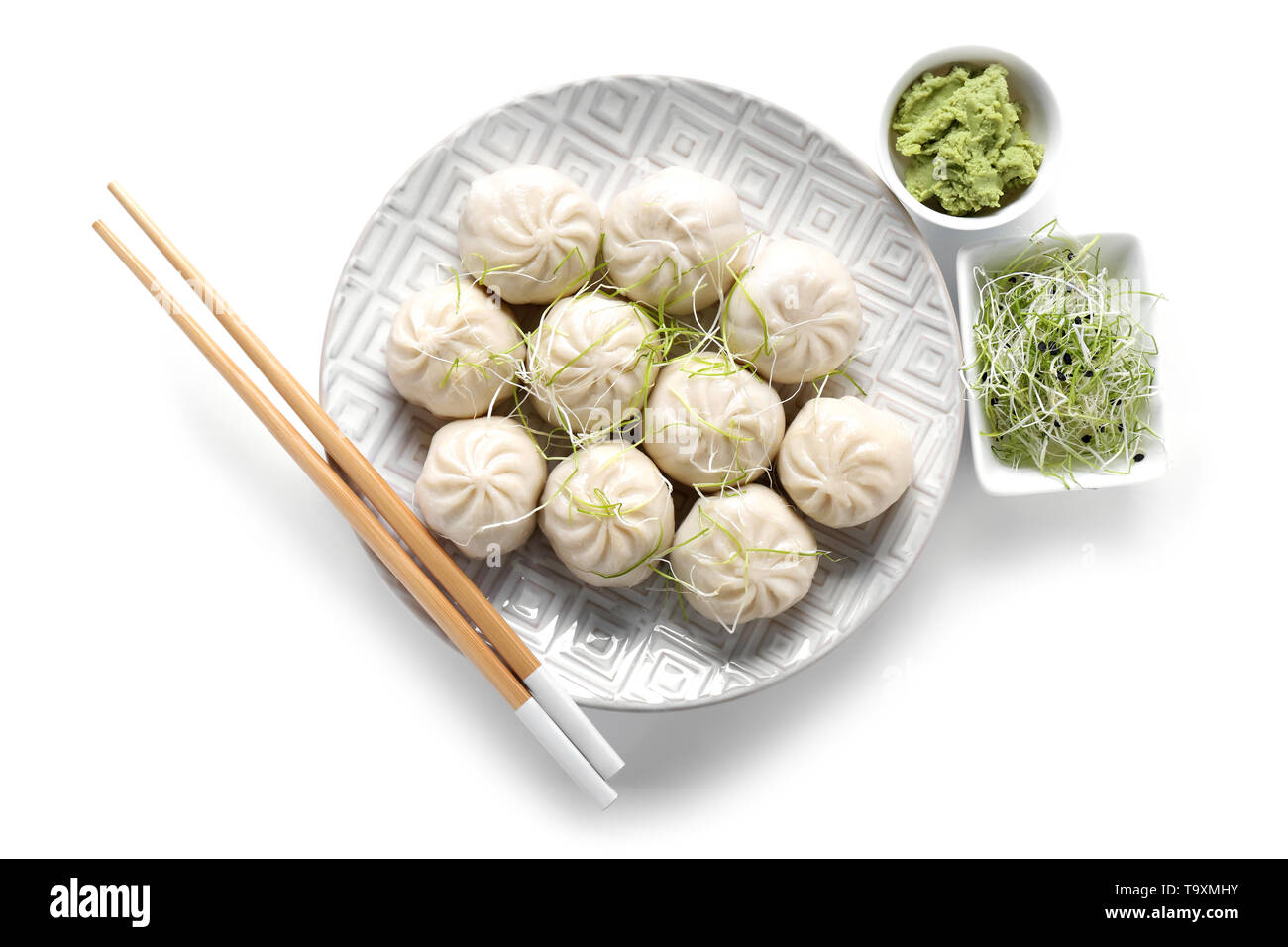 Plate with tasty Chinese dumplings, wasabi and sprouts on white ...