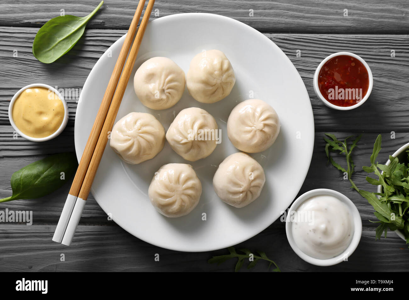 Plate with tasty Chinese dumplings on table Stock Photo - Alamy