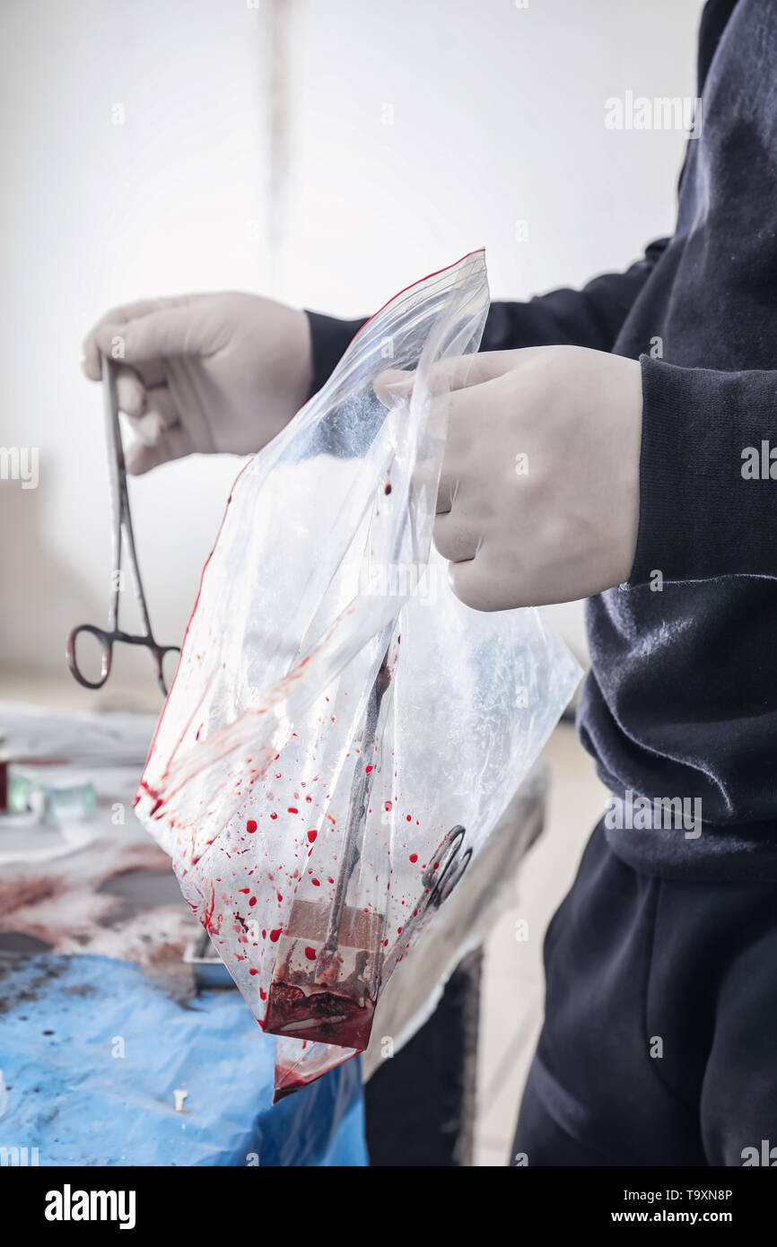 Criminalist working with evidences at the scene of crime Stock Photo ...