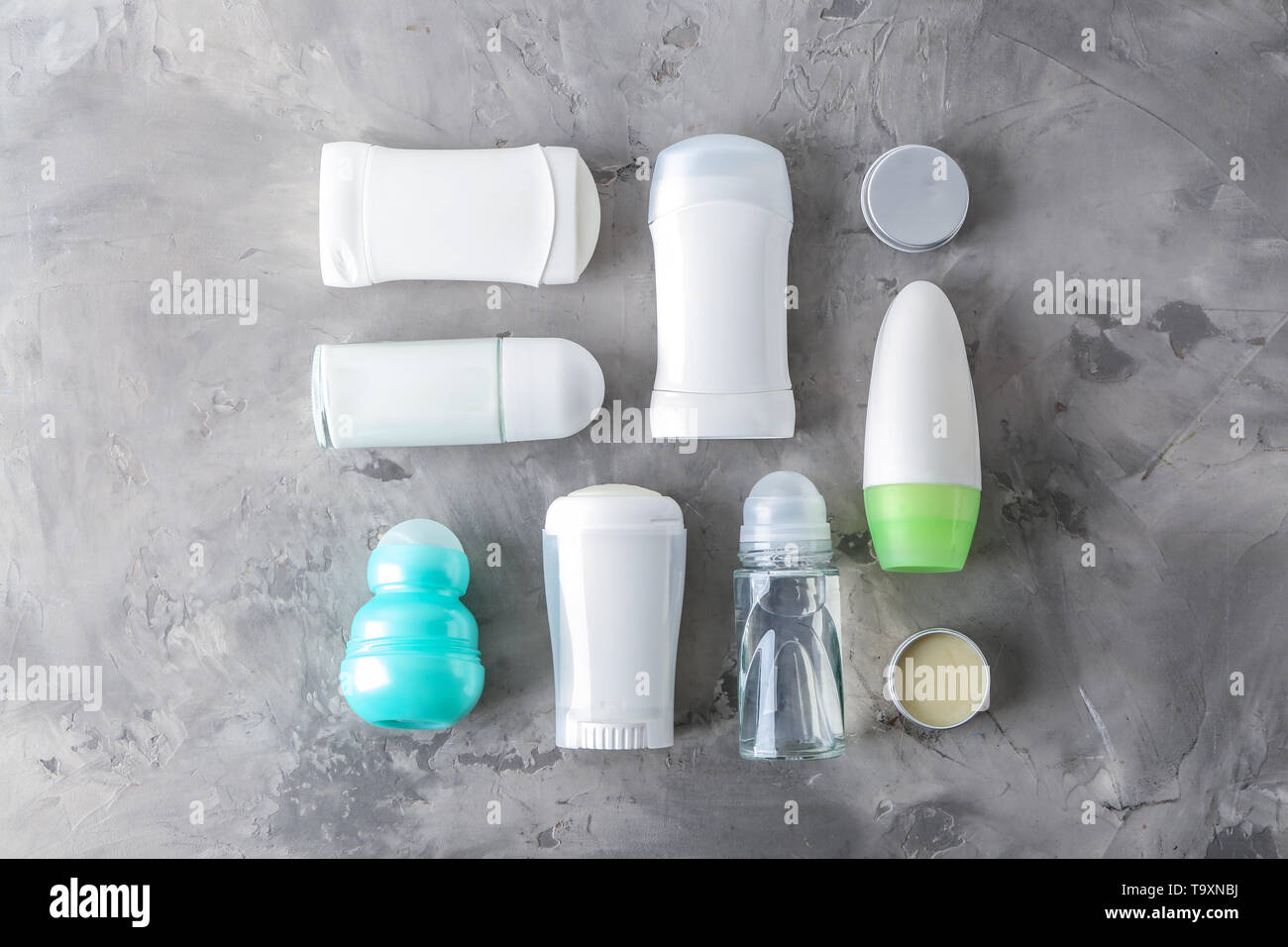 Different deodorants on grey background Stock Photo - Alamy