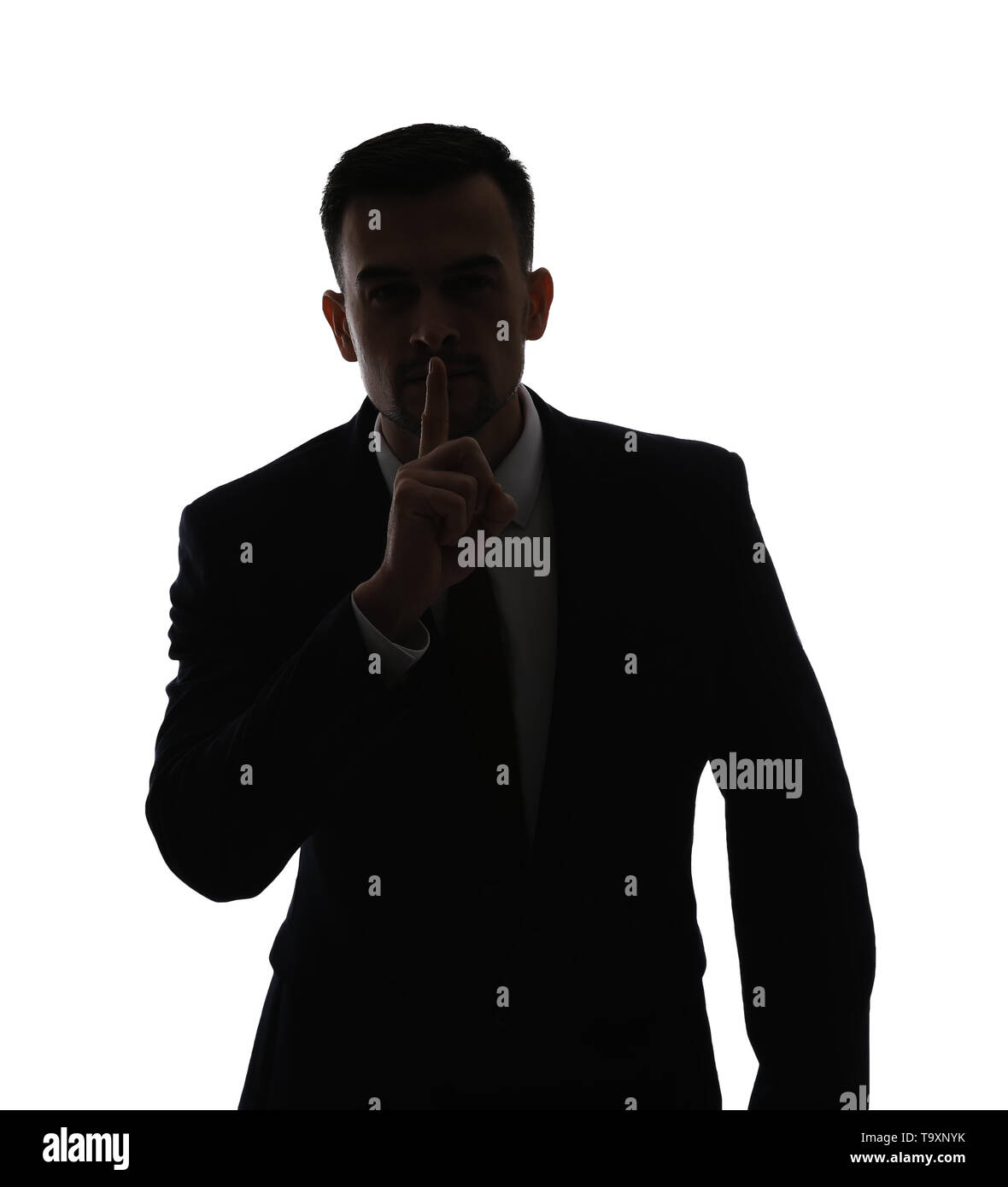 Silhouette of young businessman showing silence gesture on white ...
