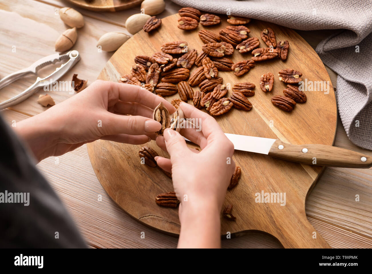 Woman cracking nuts hi-res stock photography and images - Alamy